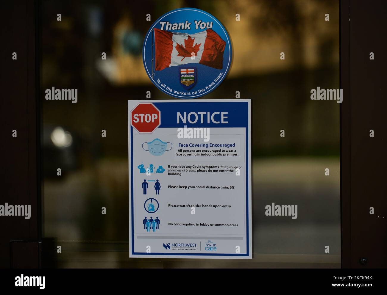 A notice with Covid-19 rules at the entrance to the pharmacy located ...