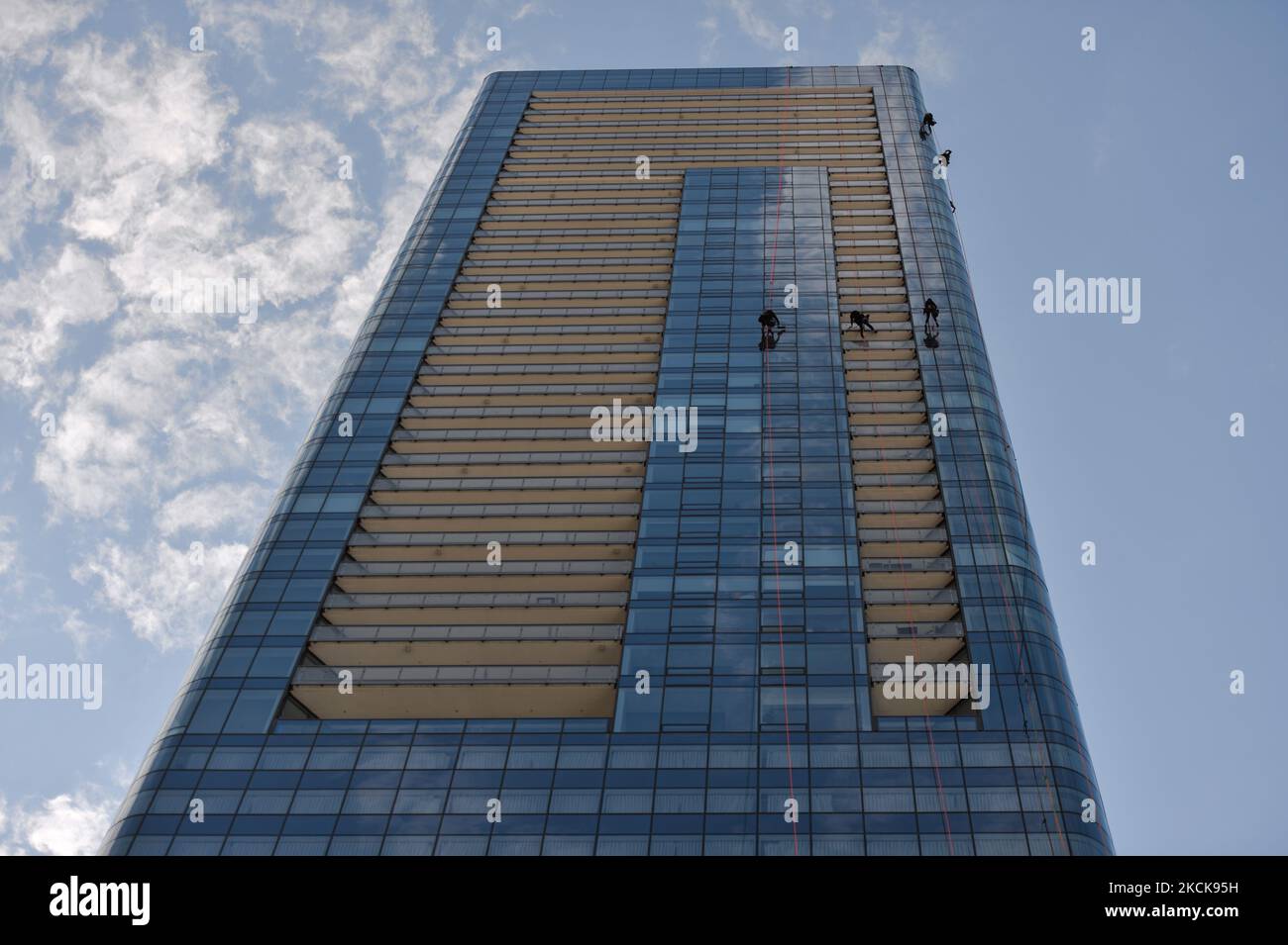 A team of climbers cleans the windows of JW Marriott Edmonton ...