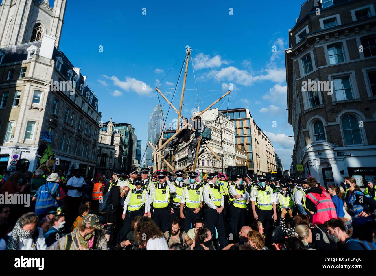 Climate activists from Extinction Rebellion build bamboo tripods at the ...
