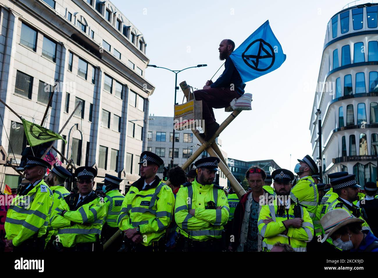 Climate activists from Extinction Rebellion build bamboo tripods at the ...