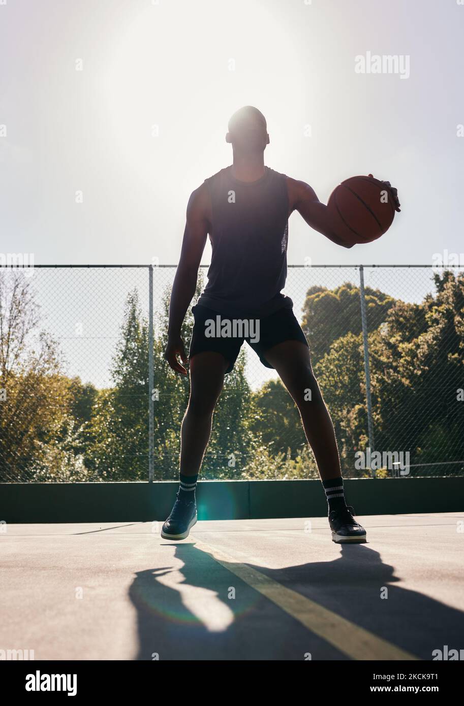 Basketball, sports and man in a park for training, cardio and exercise ...