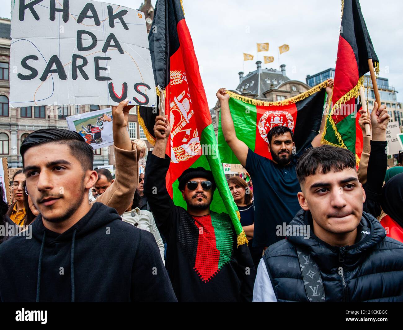 Afghan people are holding Afghan flags, during the demonstration in ...