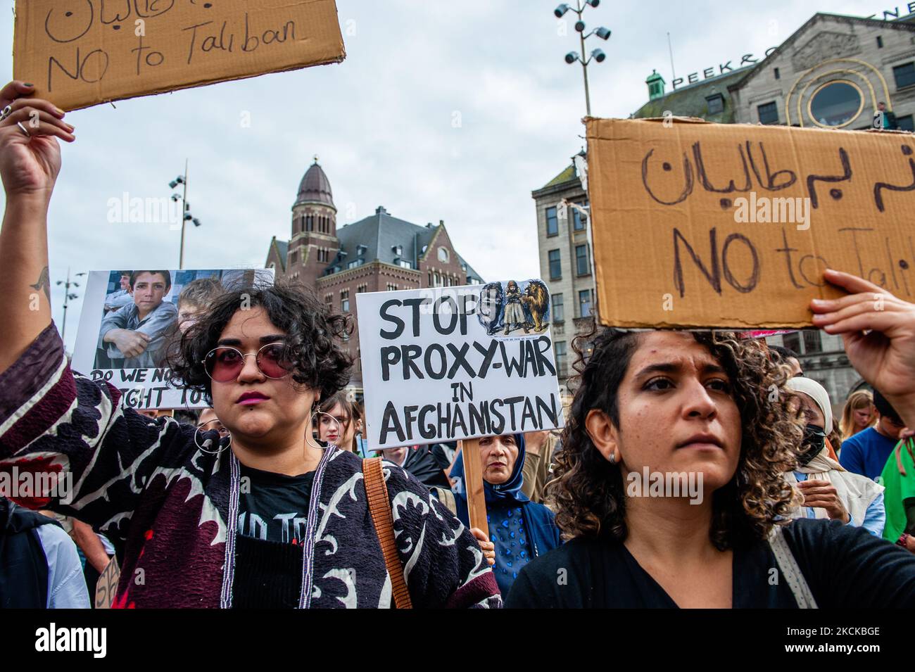 An old Afghan woman is holding a placard against the war in her country ...