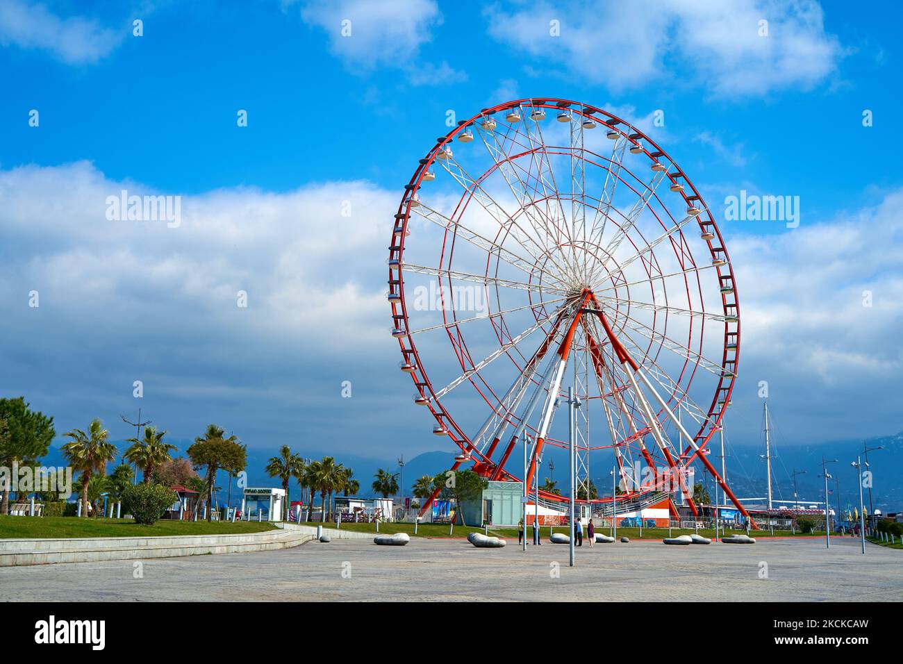 The Ferris wheel is red and white against the sky Stock Photo - Alamy