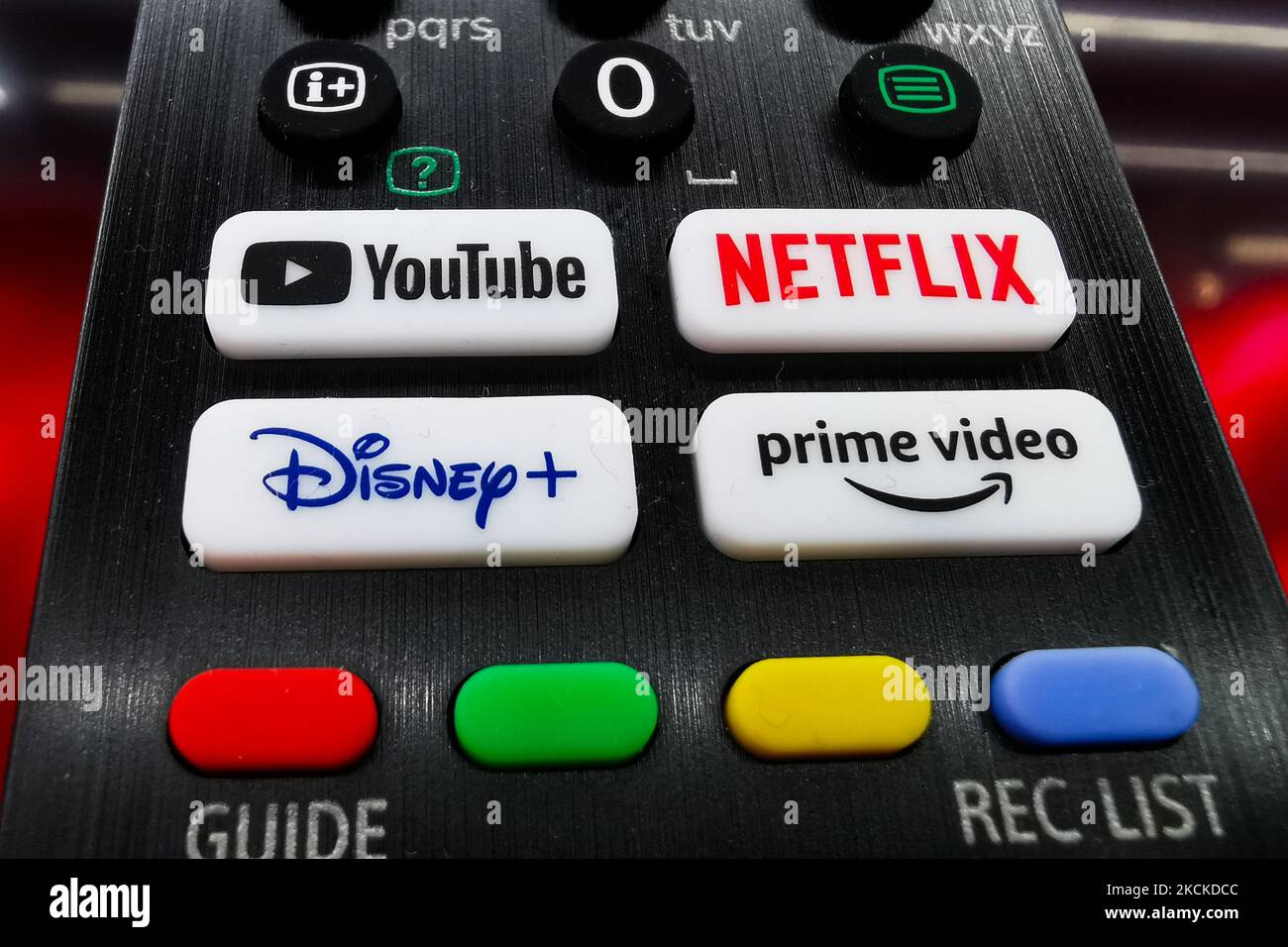 A detail of TV remote control with streaming platform buttons is seen ...