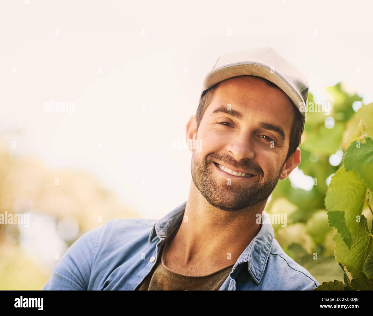 My farm is my happy place. Portrait of a cheerful young farmer posing ...