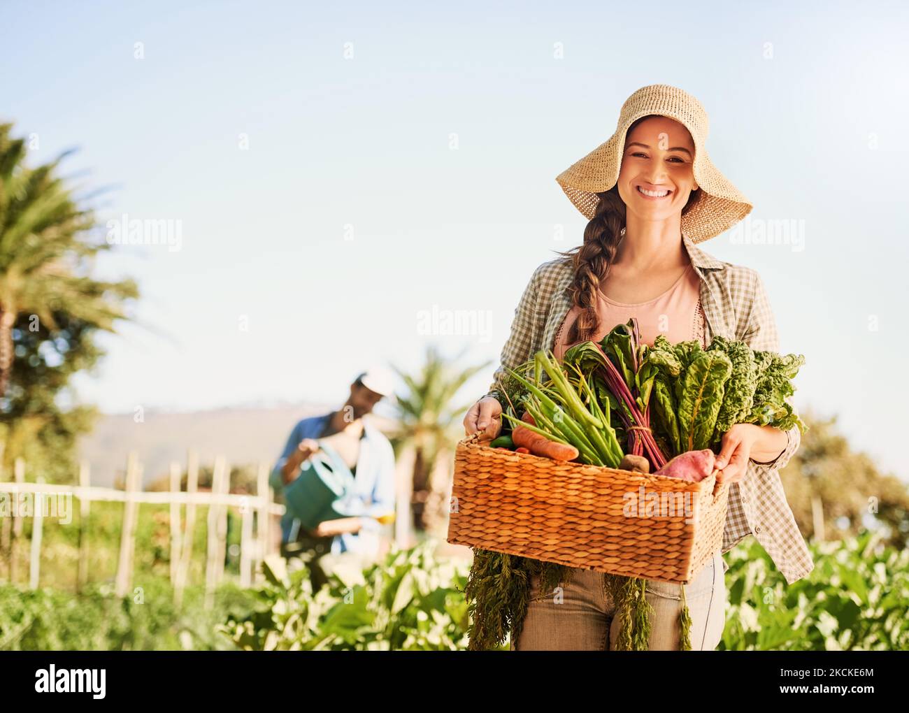 Were proud of our produce. Portrait of a happy young farmer harvesting ...