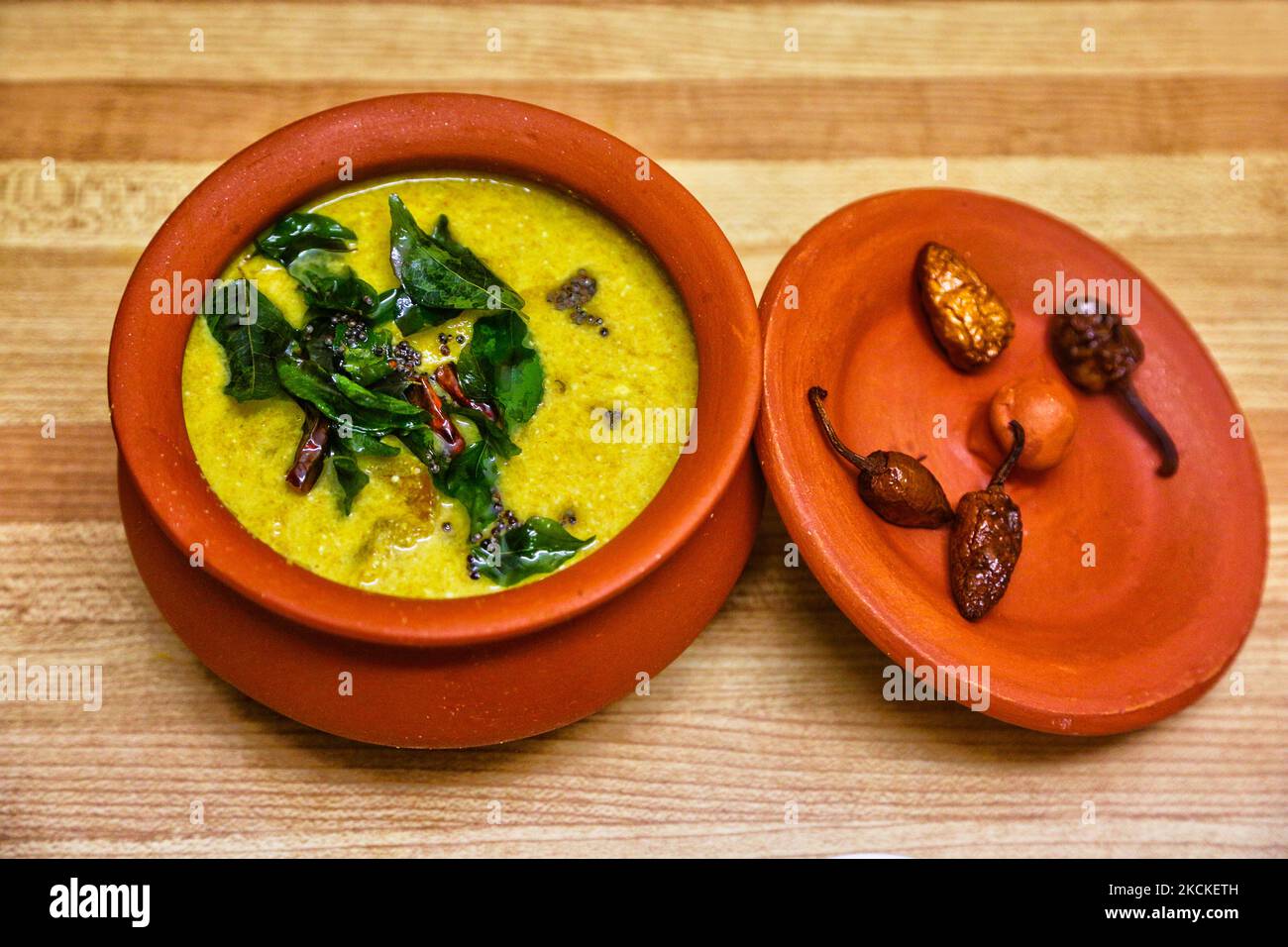 Pot containing maambazha pulissery (mango curd curry) during a ...