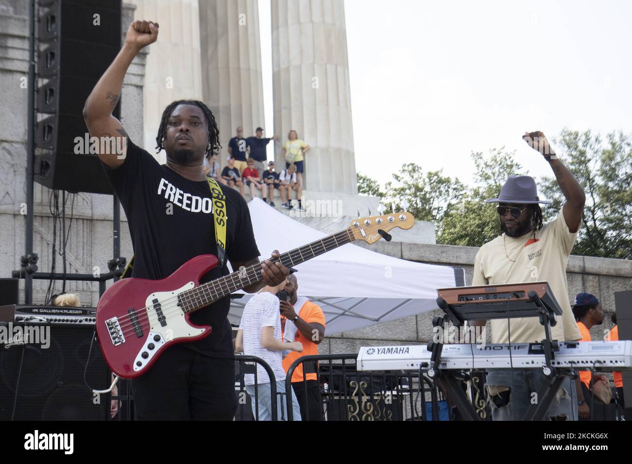 Members of the Black Alley go-go band raise their fists while they ...