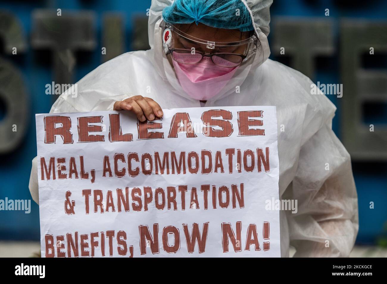 A Filipino health worker calling for the release of the benefits for ...