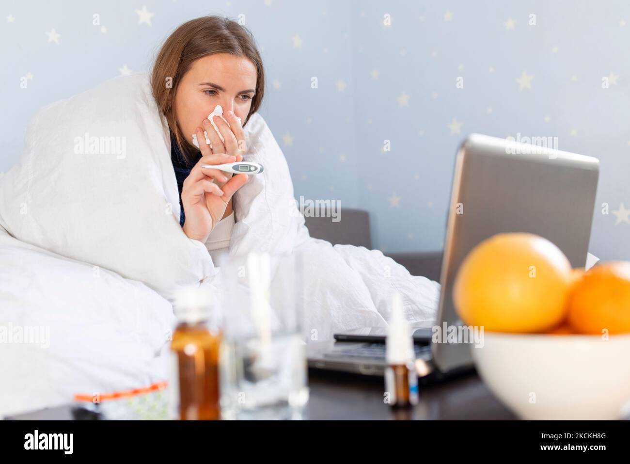 Sick young woman with bad cold, flu or fever holding thermometer Stock ...