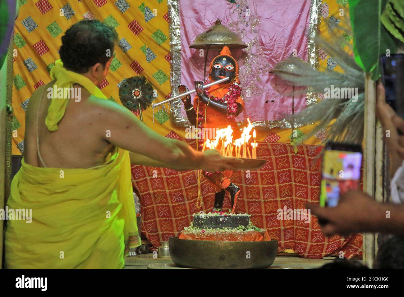 A priest perform worship to Lord Krishna on the occasion of ' Krishna ...