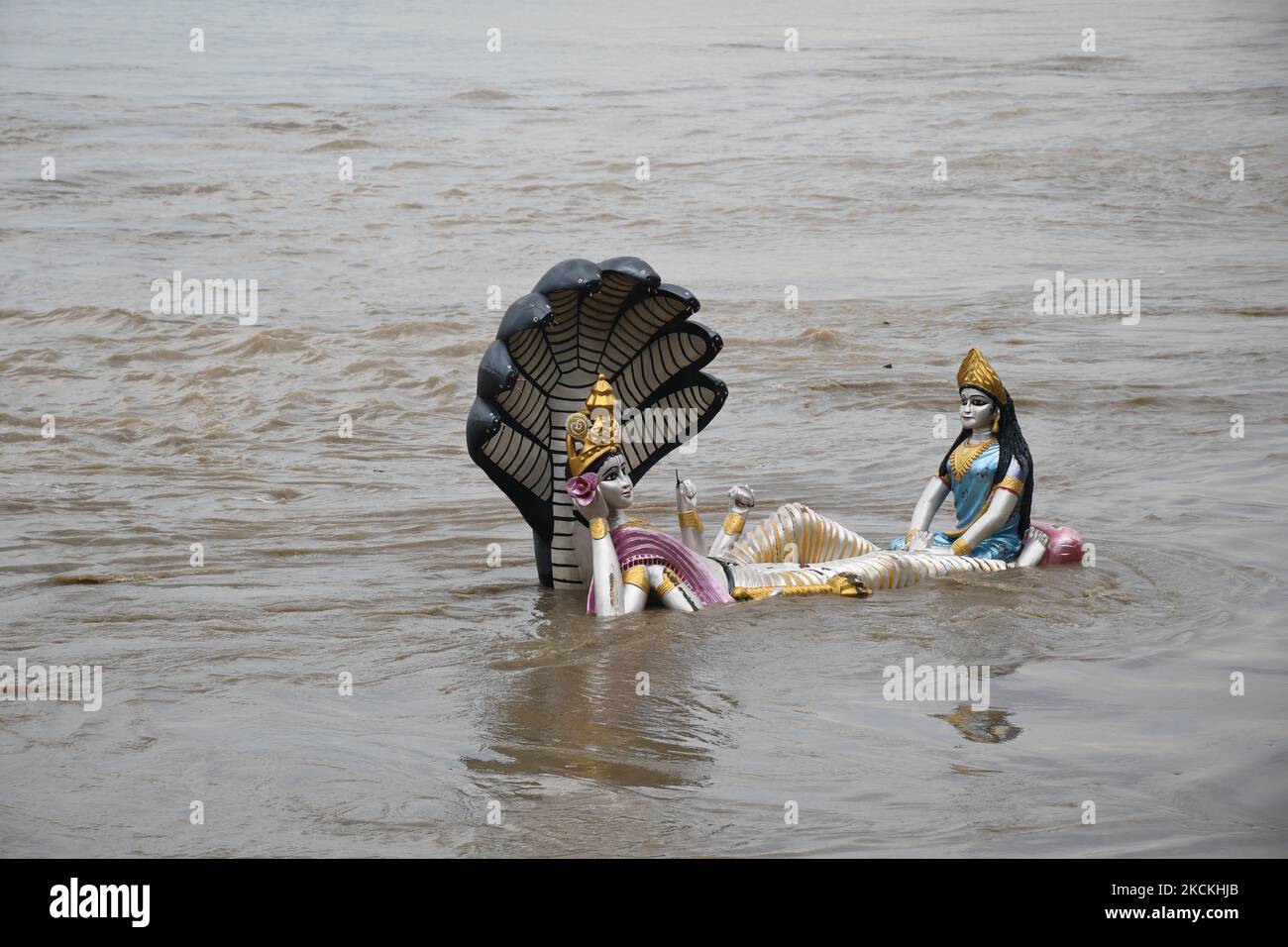 A statue of Lord Vishnu is seen submerged in the swollen Brahmaputra ...