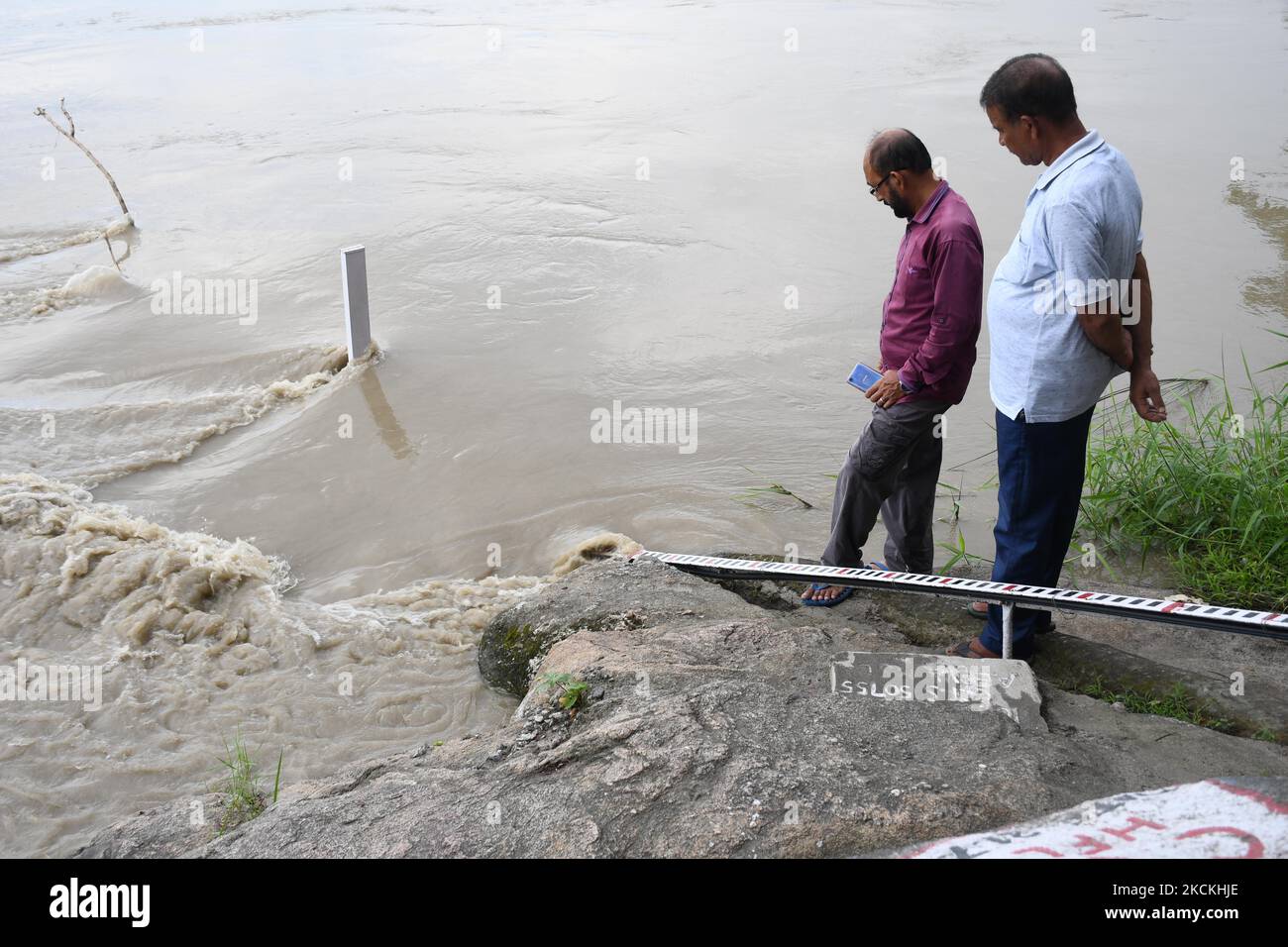 An employee of Central Water Commission (CWC) measures the temperature ...