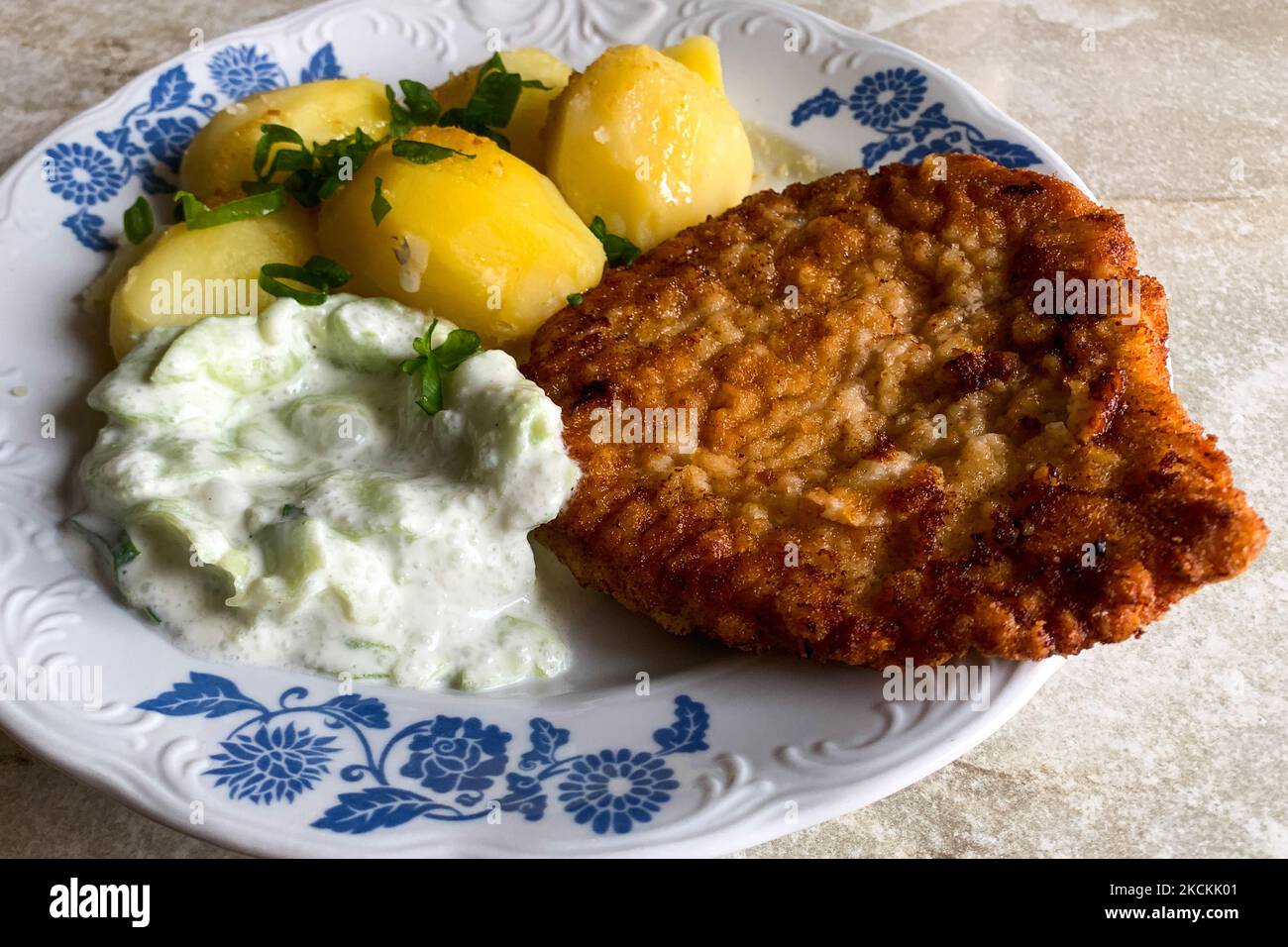 Traditional polish breaded pork chop called kotlet schabowy, salad with ...