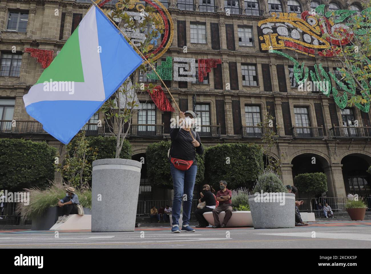 A supporter of the vegan movement holds a flag as members of the ...