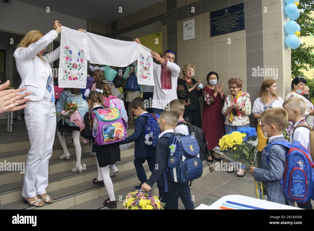 First graders attend a ceremony to mark the start of the new school ...
