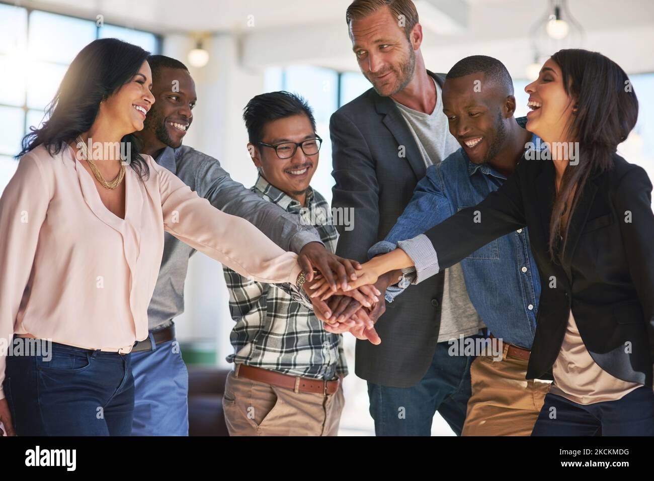 Finding their strength in unity. a team of creative colleagues putting ...