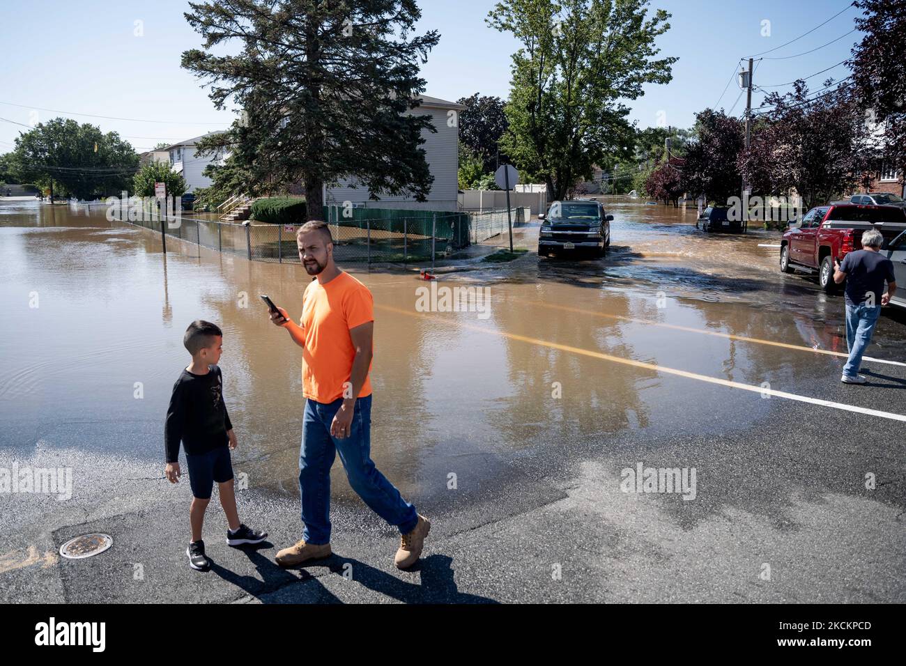 Residents survey flooding following torrential rains from the remannts ...