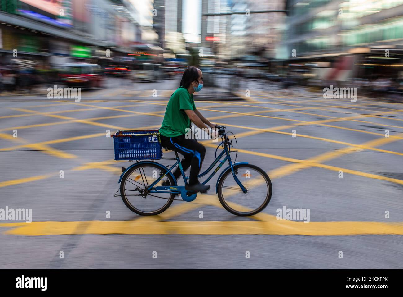 A delivery man crosses Cheung Sha Wan road on his bicycle in this ...