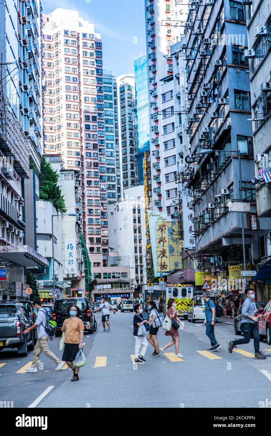 People cross Castle Peak Road in Lai Chi Kok, as buildings stand in the ...