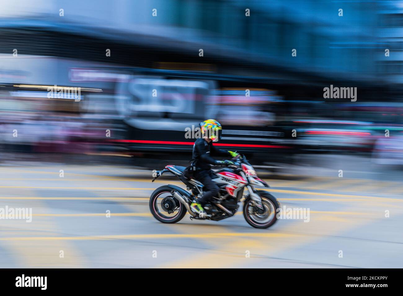 A biker crosses Cheung Sha Wan road on his bike. (Photo by Marc ...