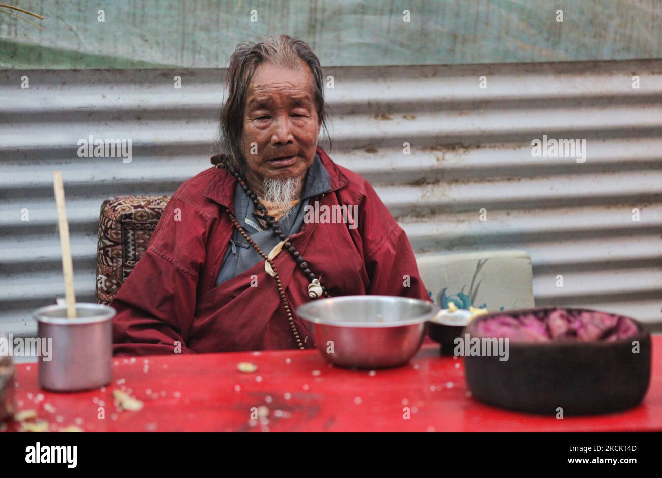 A 90 year-old Lepcha Bomthing (Lepcha priest) chants prayers during an ...