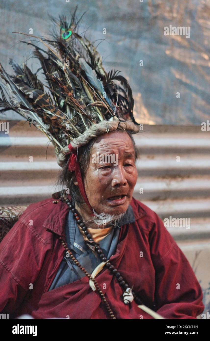 A 90 year-old Lepcha Bomthing (Lepcha priest) wearing a feathered hat ...