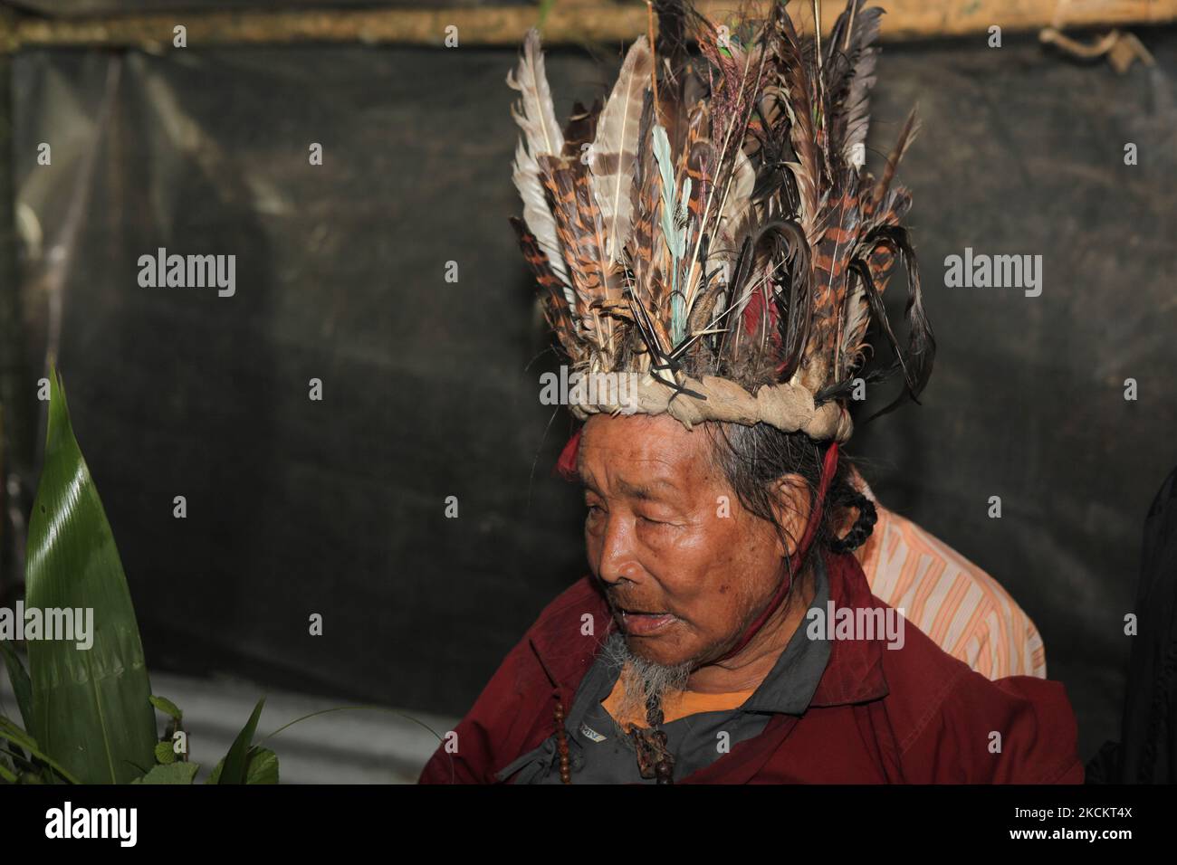 A 90 year-old Lepcha Bomthing (Lepcha priest) wearing feathered hat ...