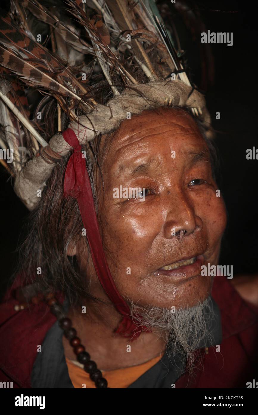 A 90 year-old Lepcha Bomthing (Lepcha priest) wearing feathered hat ...