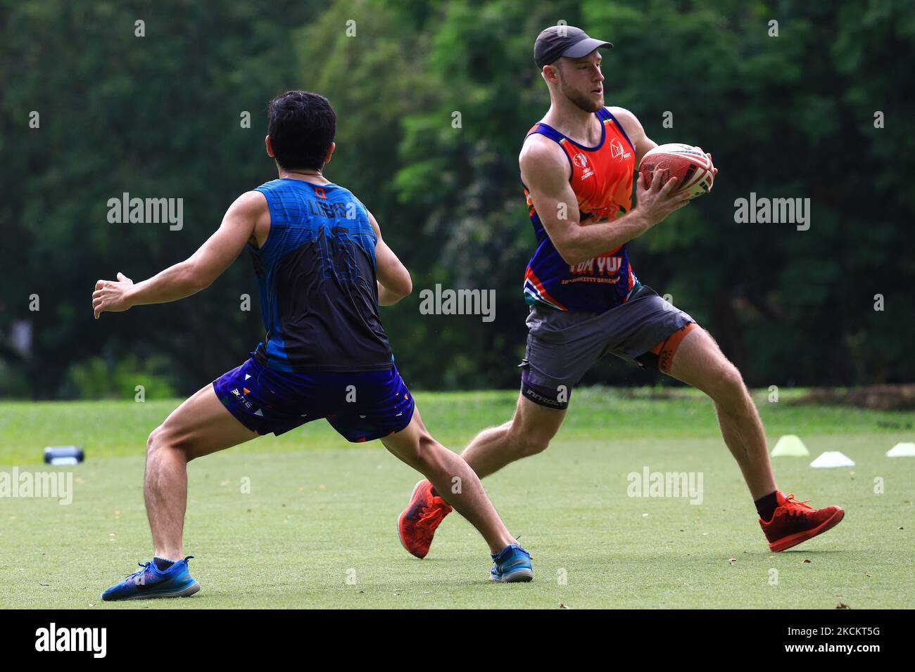 People play touch rugby at a park on September 4, 2021 in Singapore ...