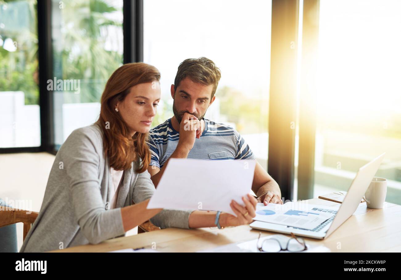 Weve got some financial decisions to make. a young couple working on ...