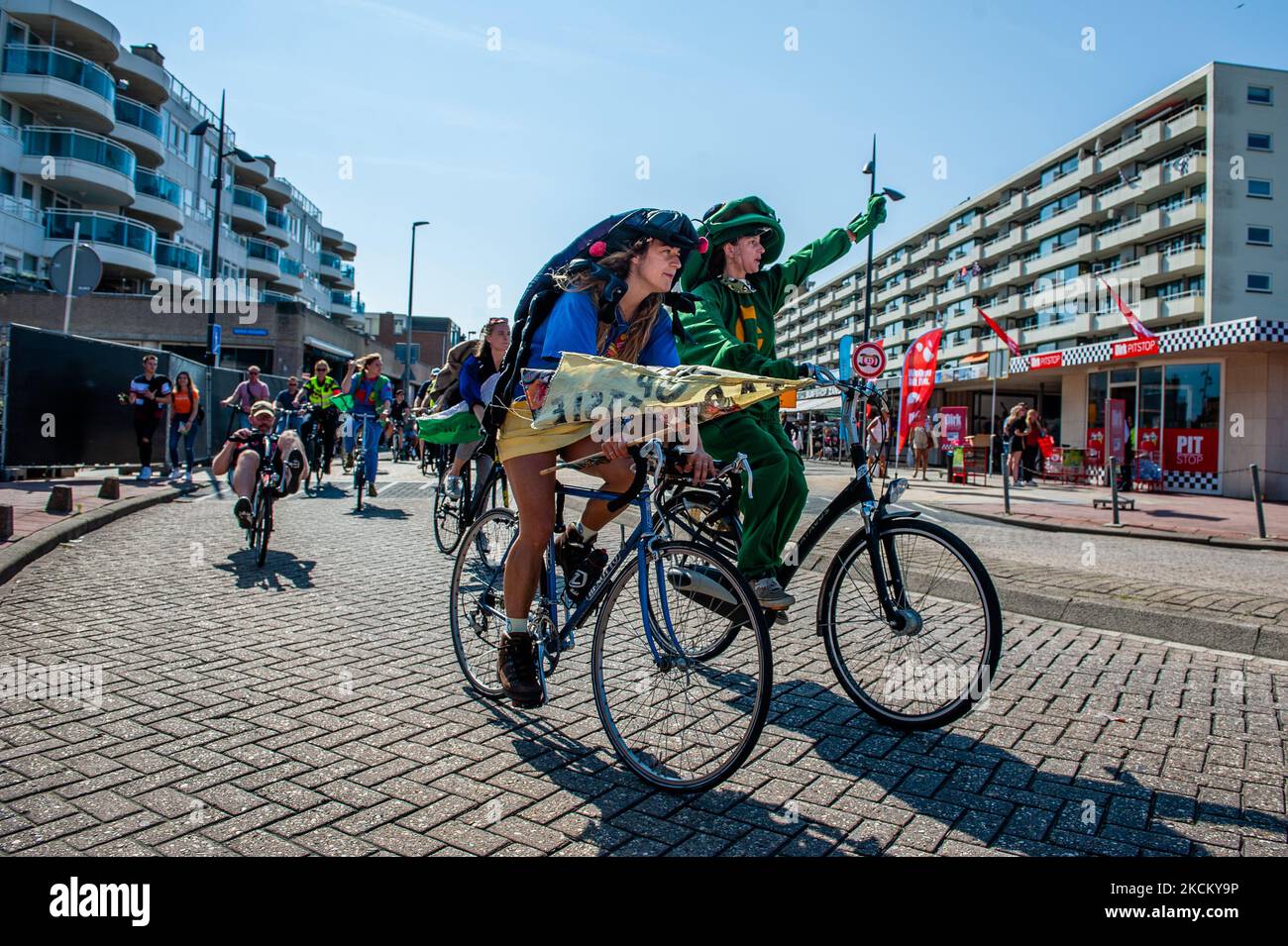 Two activists from Extinction Rebellion are riding their bikes wearing ...