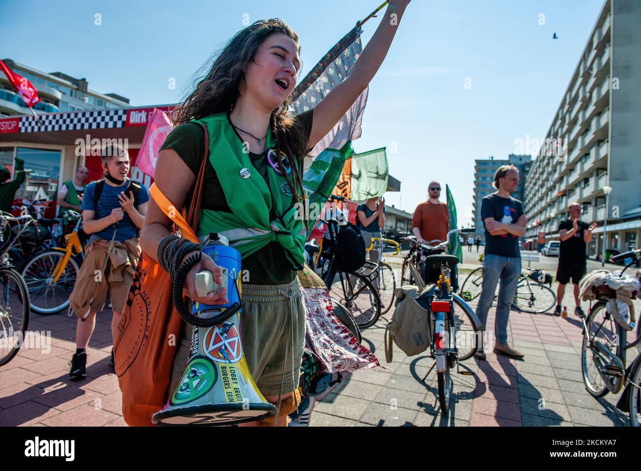 An Extinction Rebellion activist is shouting climte slogans, during the ... An Extinction Rebellion activist is shouting climte slogans, during the ...