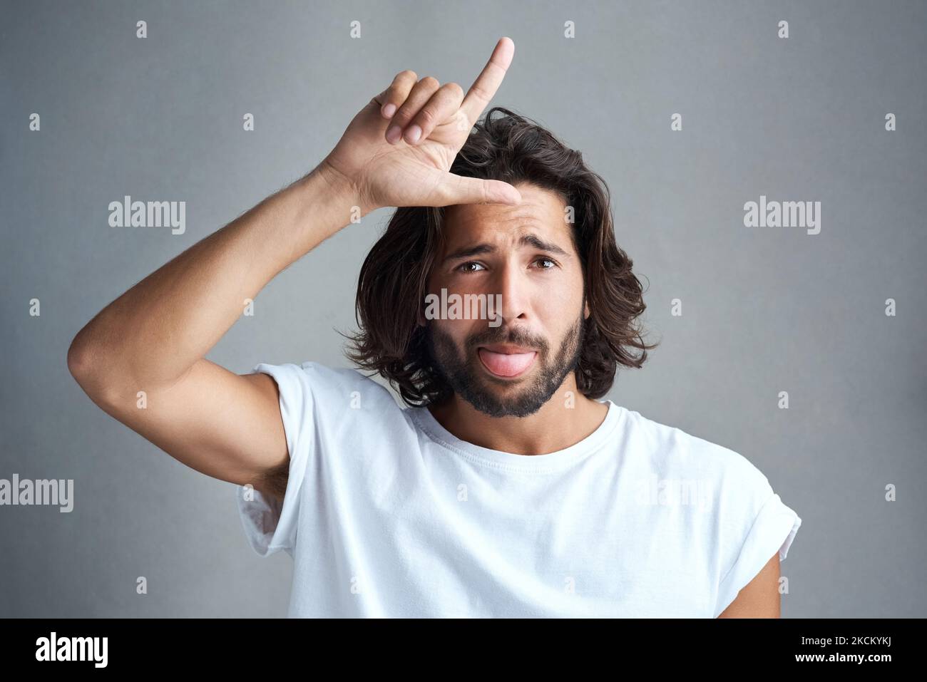 Do you like failing. Studio portrait of a young man showing a loser ...