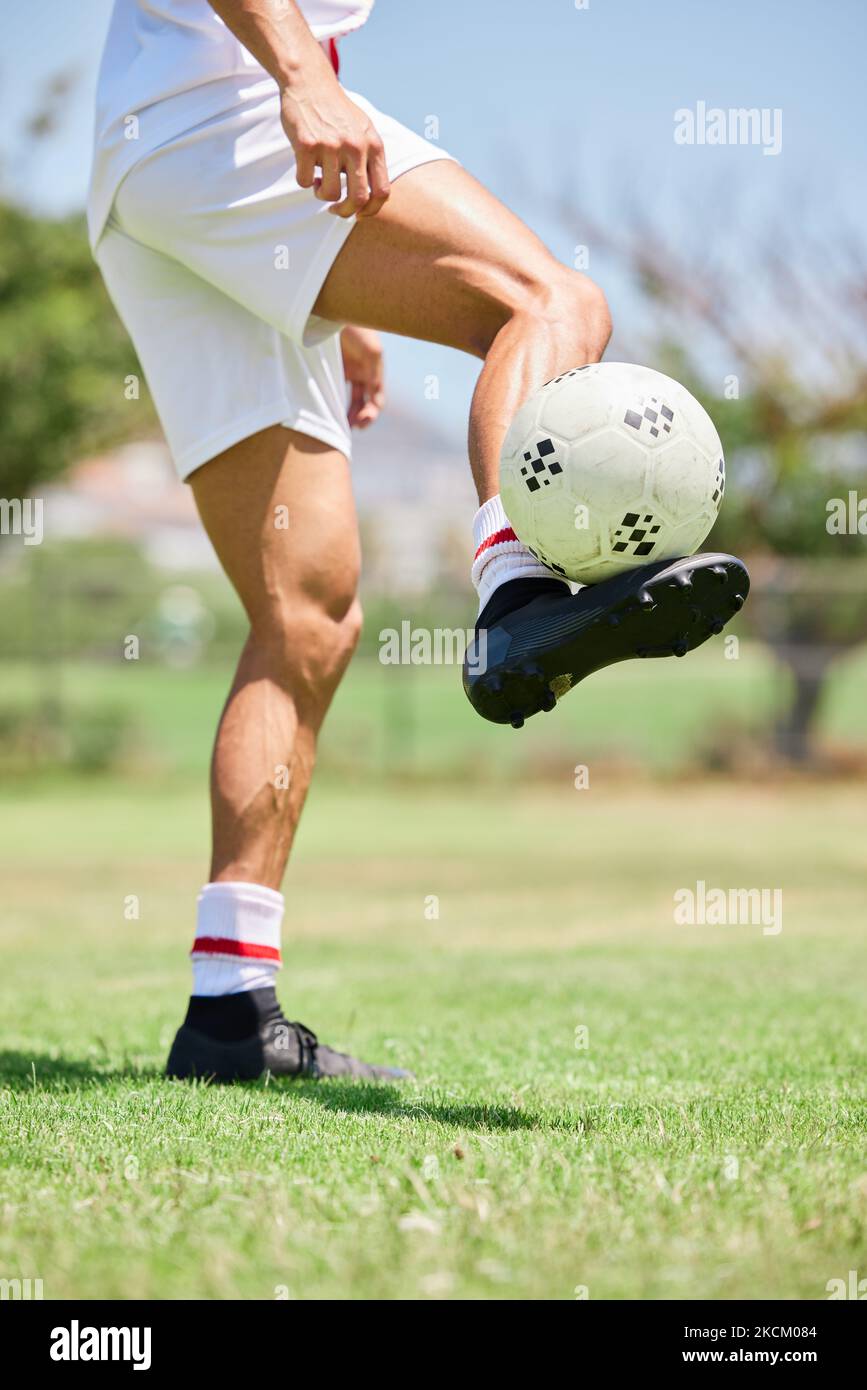 Football, soccer player and balance ball on foot on a grass field ...