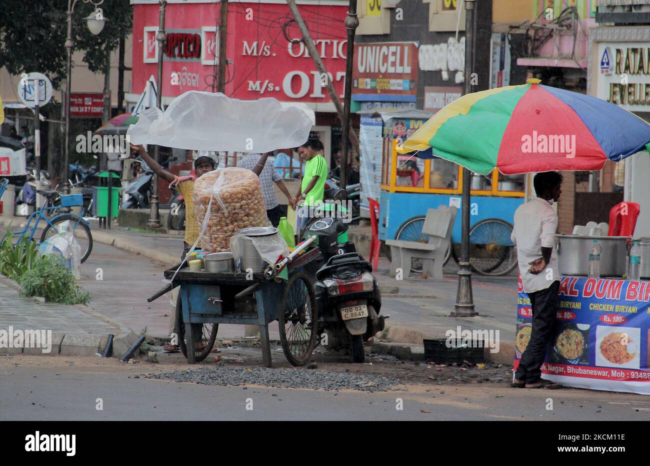 A way side snacks vendor covers his vending business trolley before the ...