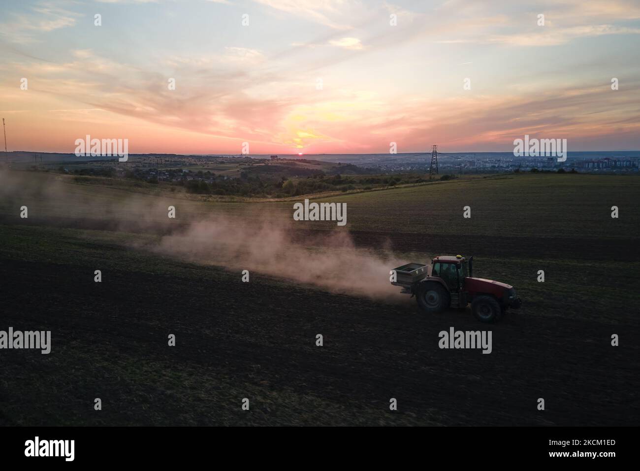 Tractor spraying fertilizers with insecticide herbicide chemicals on ...