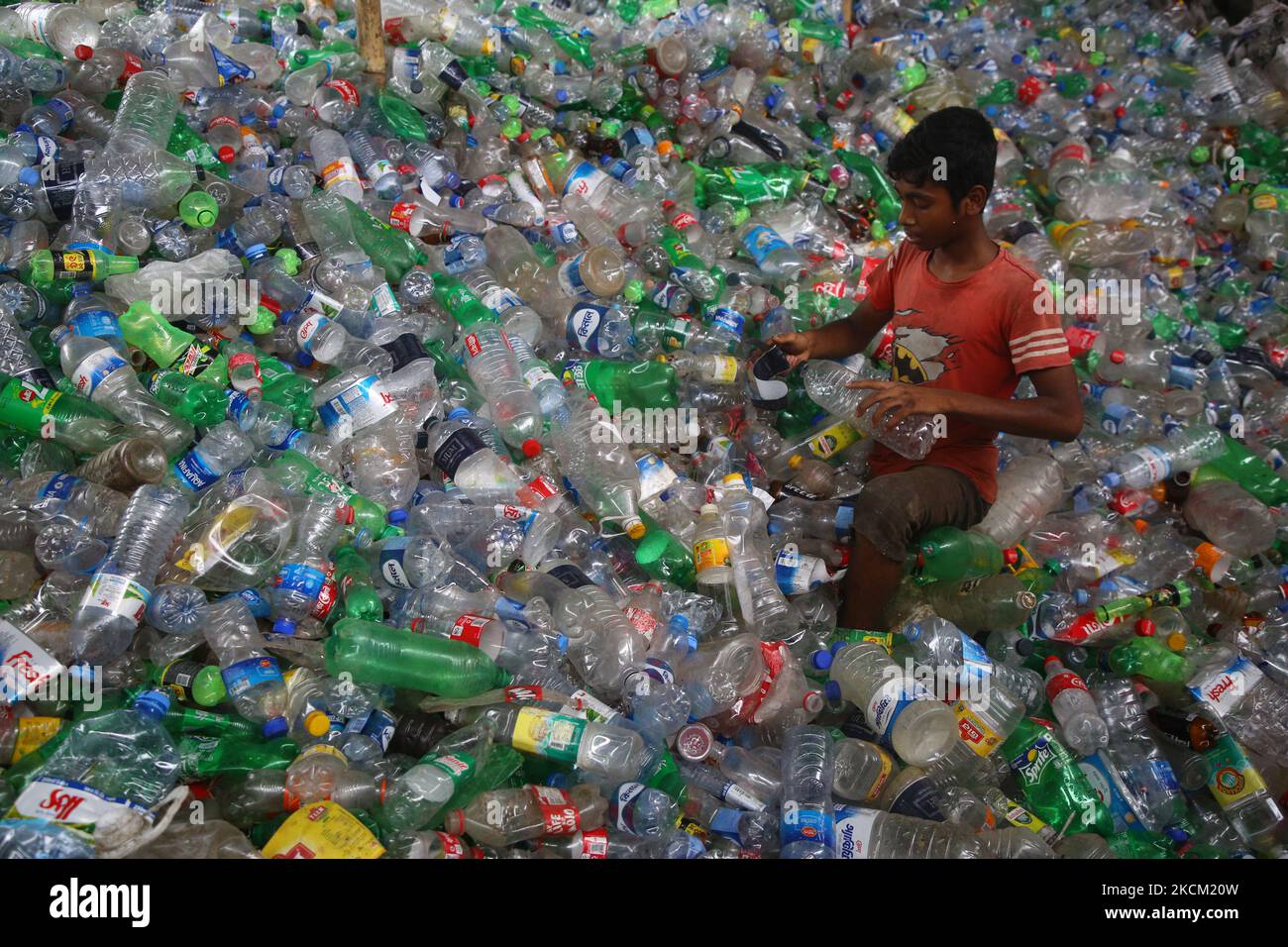 A child works in a plastic bottle recycling factory in Dhaka, Bangladesh. (Photo by Sony Ramany ...