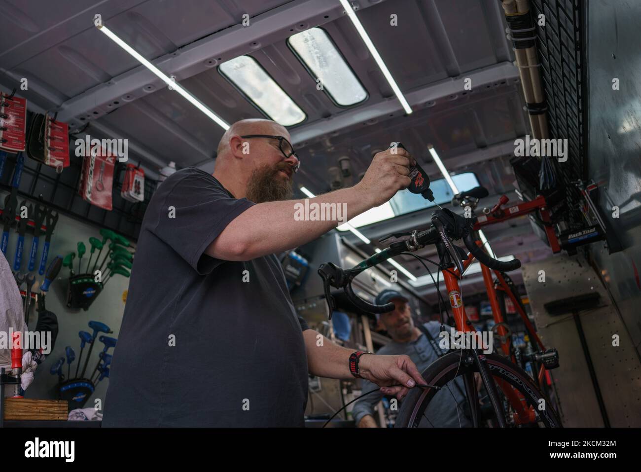 Merlyn Townley works on bikes as cyclists of the Quell Foundation ...