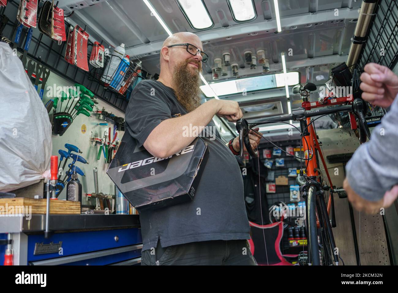 Merlyn Townley works on bikes as cyclists of the Quell Foundation ...