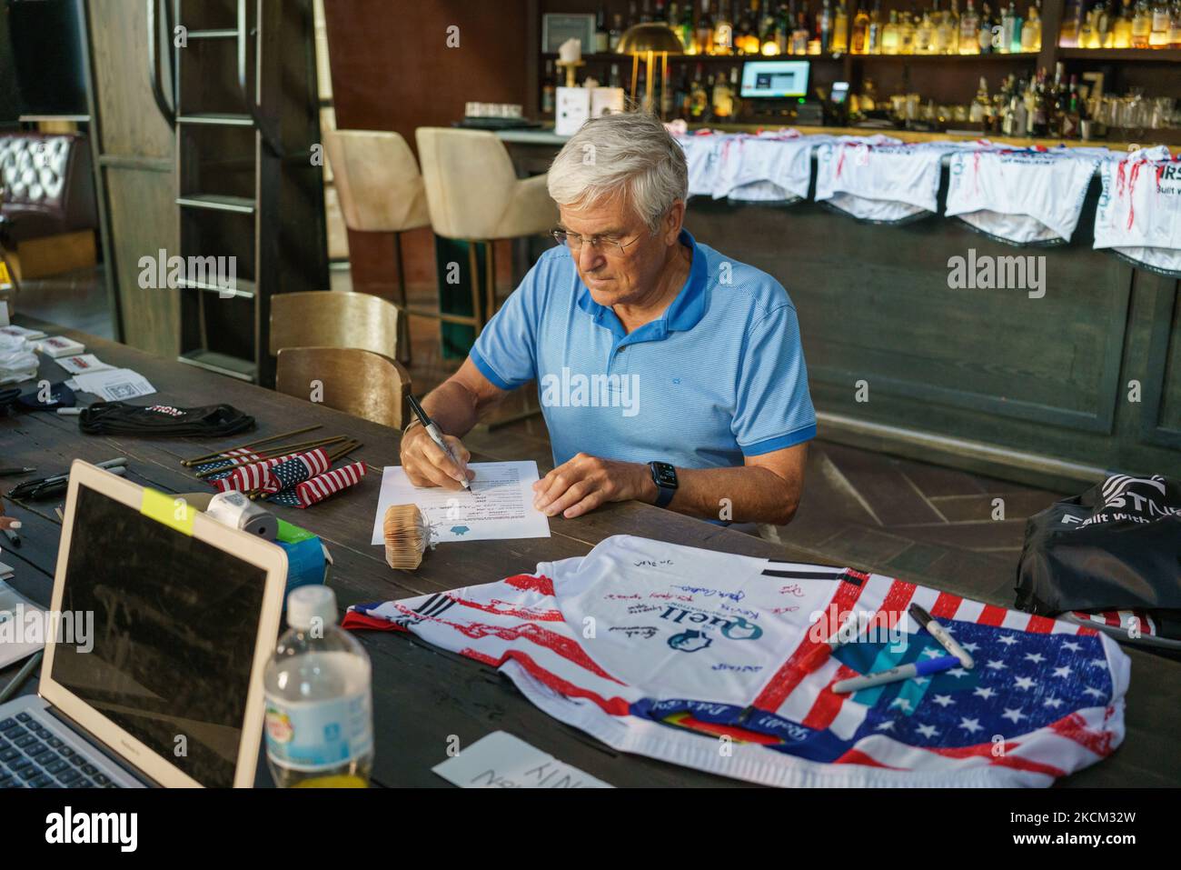 General George Casey signs in at registration as cyclists of the Quell ...