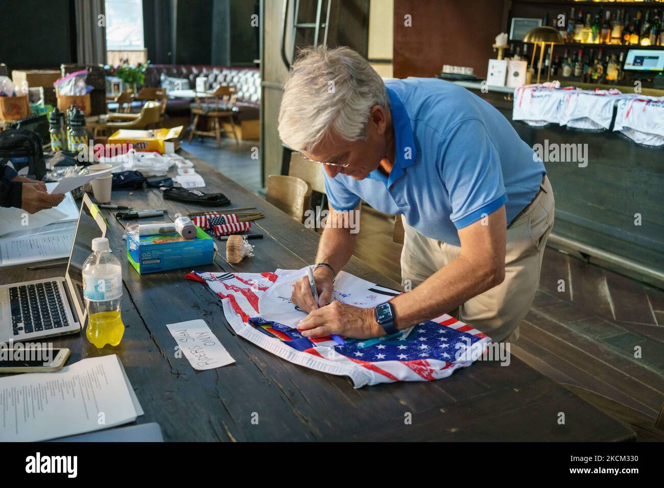 General George Casey signs in at registration as cyclists of the Quell ...
