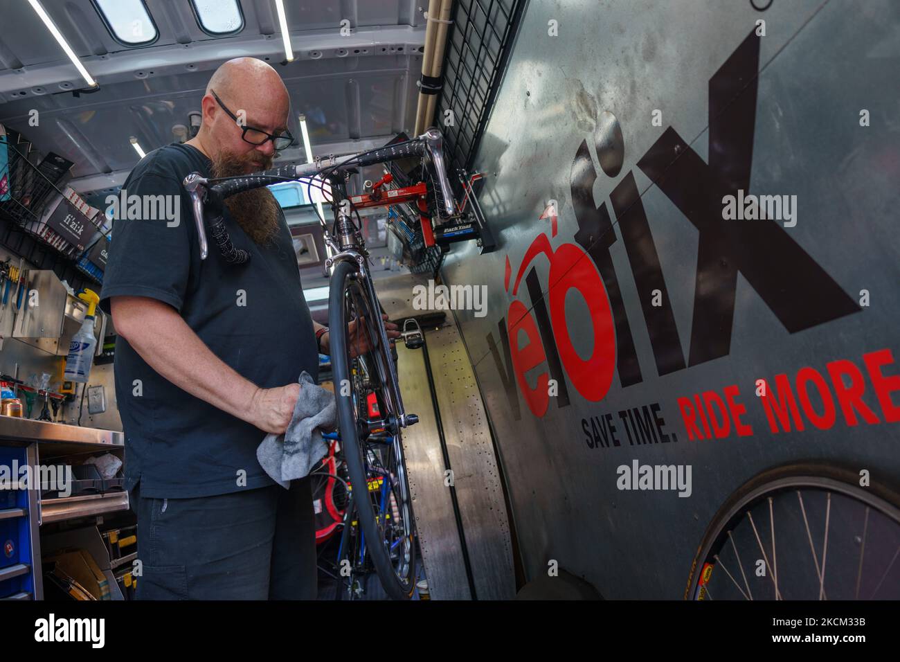 Merlyn Townley of Velofix prepares bicycles for riders as cyclists of ...