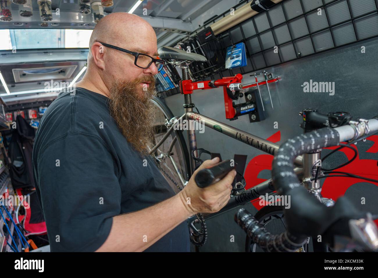 Merlyn Townley of Velofix prepares bicycles for riders as cyclists of ...