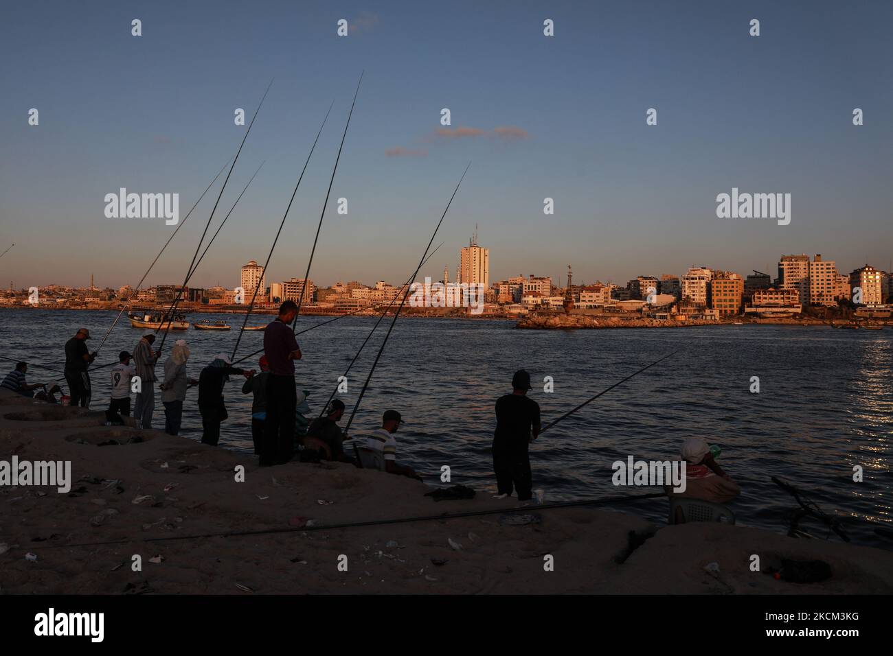 Palestinian fishermen fish at the port of Gaza City on September 7 ...