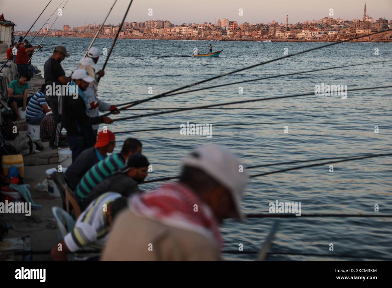Palestinian fishermen fish at the port of Gaza City on September 7 ...
