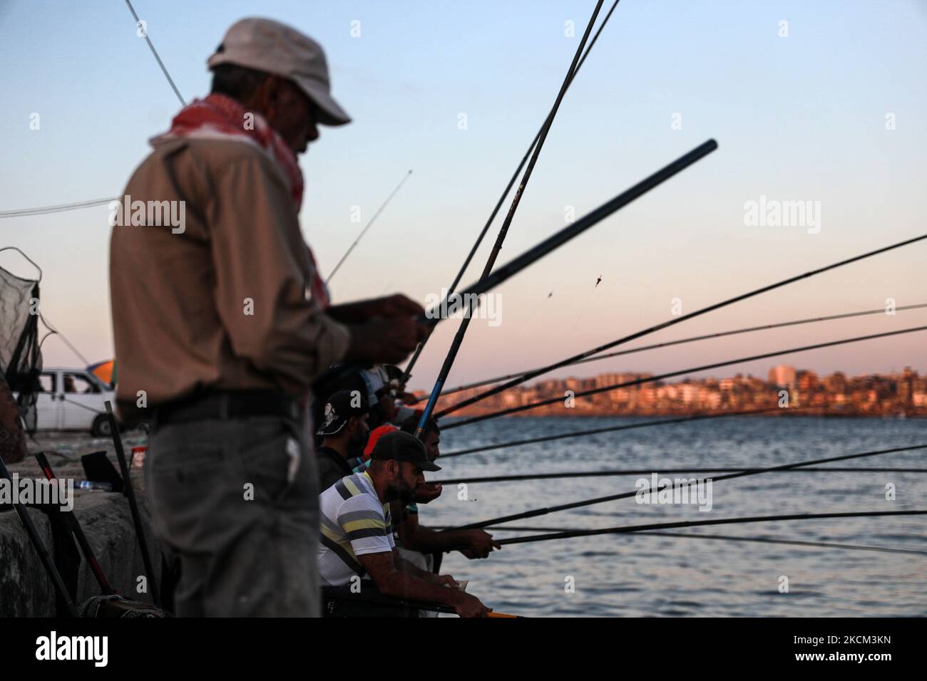 Palestinian fishermen fish at the port of Gaza City on September 7 ...