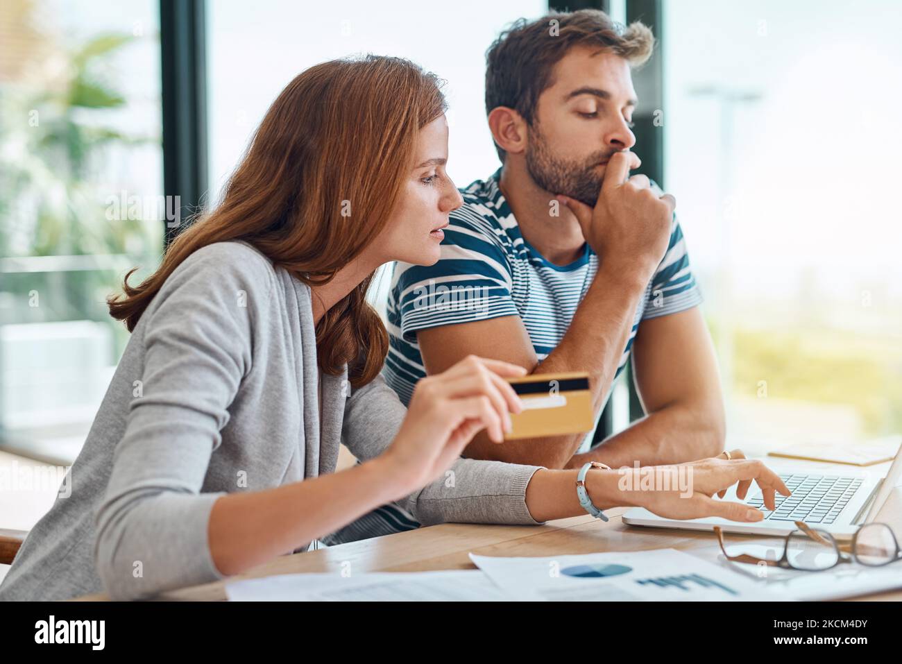 Hes not convinced one bit. a young couple working on their household ...