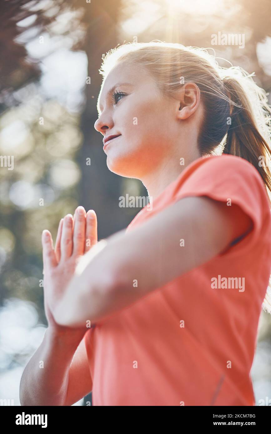 Pray for a positive outcome. a young woman with praying hands outdoors ...